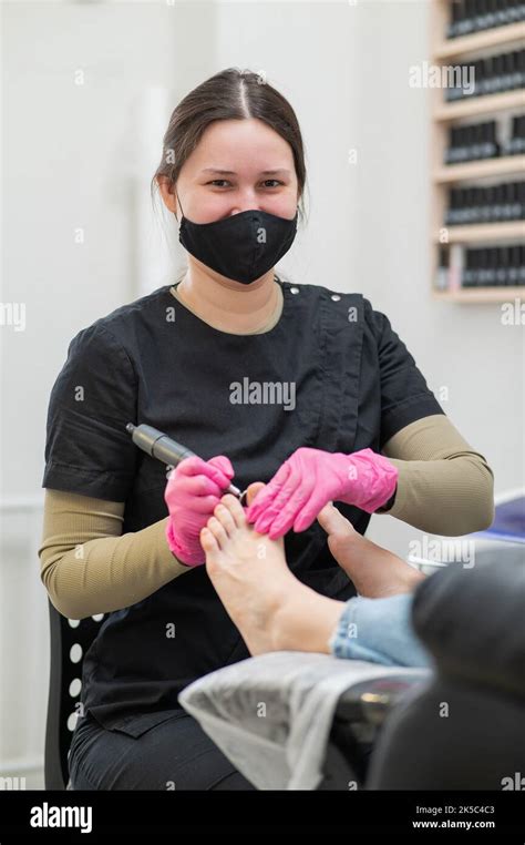 The Pedicure Master Processes The Clients Foot Using An Apparatus With