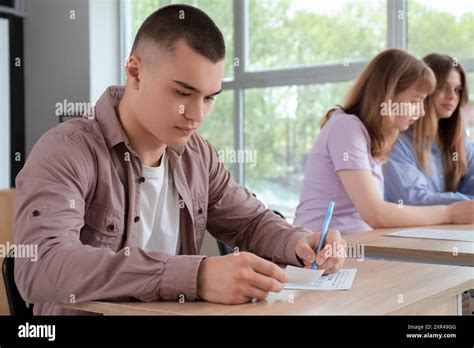 Male Babe Cheating On Exam In Classroom Stock Photo Alamy