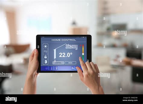 Woman Using Tablet To Set Indoor Temperature Closeup Smart Home