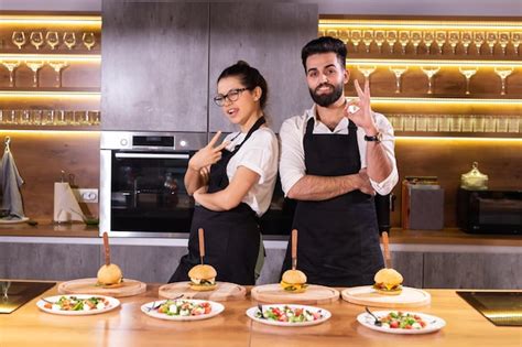 Premium Photo Happy Chef And His Colleague Standing At Kitchen And