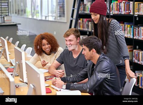 Students Unite Students Working On Computers In A University Library
