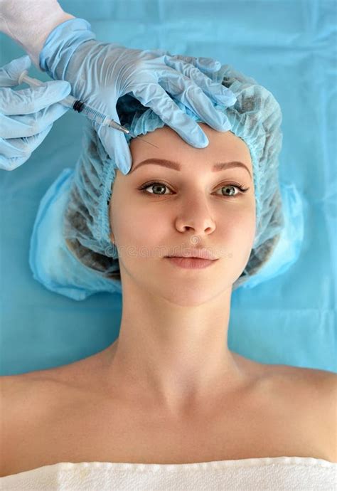 Cosmetologist Does Injections On The Face Of A Beautiful Woman In A