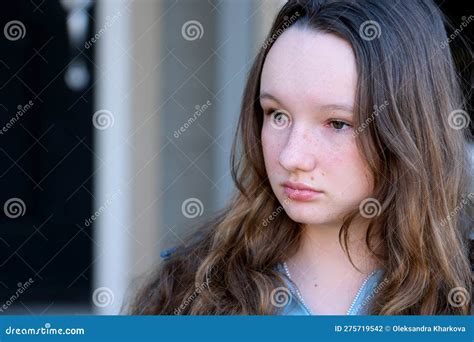 Beautiful Face Of A Young Teenager Girl Close Up Girl Leaned Over Draws Or Writes Looks Down