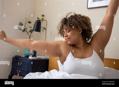 Woman Stretching In Bed Stock Photo Alamy