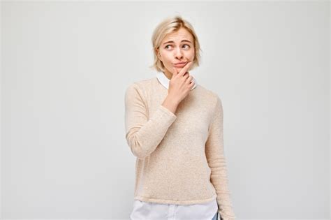 Premium Photo Pensive Woman With Hand On Chin Looking Away Isolated