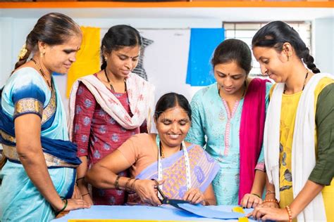 Trainer Explaining Or Guiding To Cut Clothes To Group Of Women Students At Training Center