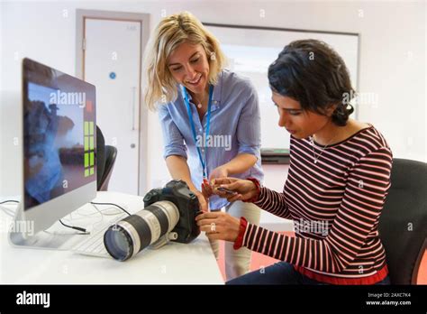 Female Photographer Teaching Babe How To Use SLR Camera Stock Photo Alamy