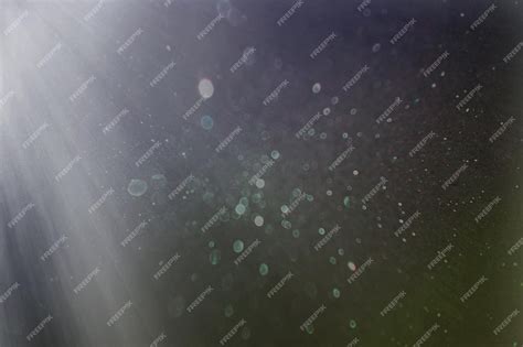 A Blurry Image Of A Green And Black Background With A Green Light