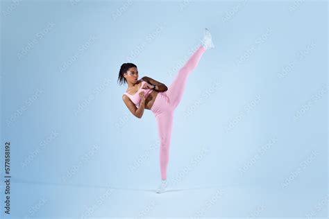 Determined Black Woman In Sportswear Doing High Kick Tae Bo Martial