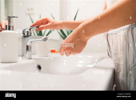 Close Up Unrecognizable Woman Opening The Faucet To Wet Her Toothbrush Stock Photo Alamy