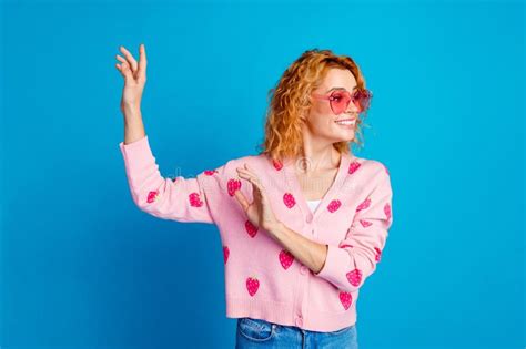 Photo Of Attractive Young Woman Touch Sunglass Have Fun Look Empty Space Dressed Stylish Pink