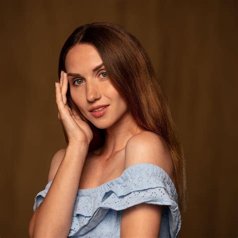 Premium Photo Portrait Of A Young Beautiful Woman On A Blurred Background