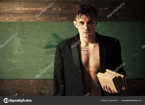 Sexy Teacher Concept Teacher On Pensive Face Muscular Figure Holds Books In Hand Man With