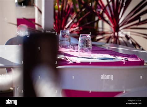 Tablecloth And Inverted Empty Glasses In Tropical Restaurant Stock