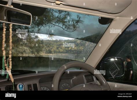 Interior Of A Car Is Photographed In A Background Of A Scenery Of Lake