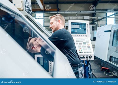 Worker Resetting A Cnc Lathe Machine In Manufacturing Factory Stock