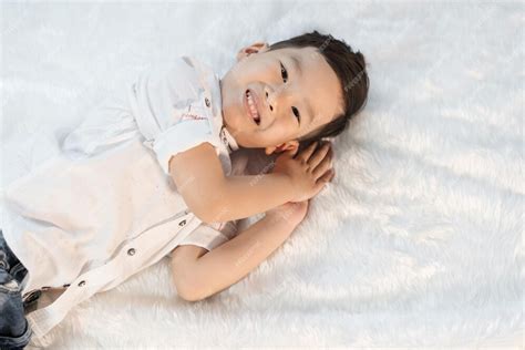Premium Photo Portrait Of Cute Girl Lying On Bed