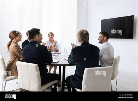 Business Conference Group Of People Watching Presentation On Tv Screen