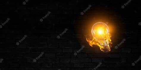 Premium Photo Classic Edison Light Bulb With Fire On Black Brick