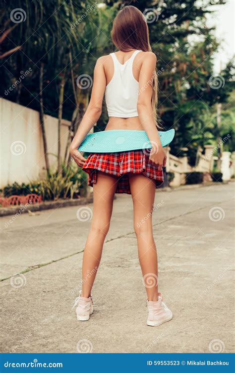 Beautiful Young Lady In Erotic Mini Skirt With A Skateboard Stock Image