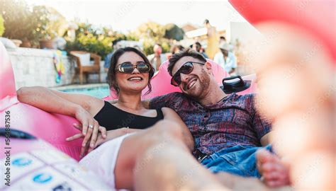 Couple Relax And Smile For Pool Party On Inflatable Floating In The