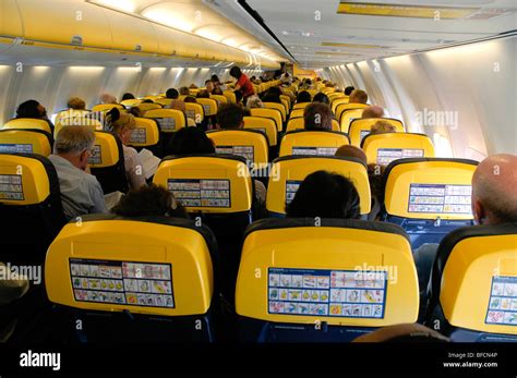 Seats And Seated Passengers During A Flight In A Ryanair Aircraft