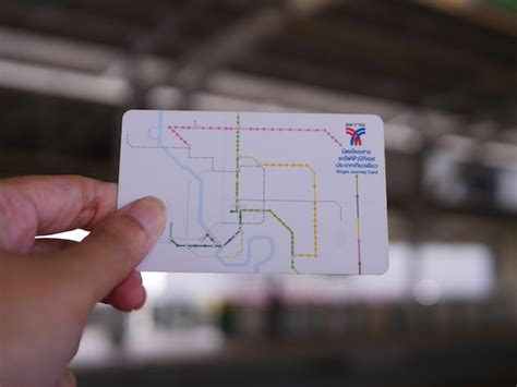 Premium Photo A Hand Is Holding A Bts Ticket And Standing For Bts At The Station