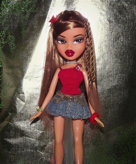 A Close Up Of A Doll With Long Hair And Red Lipstick On Her Face Wearing A Denim Skirt
