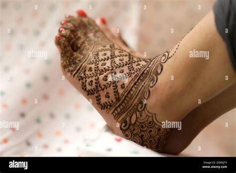 Ledy Feet And Hands In Heena For Wedding In White Background And