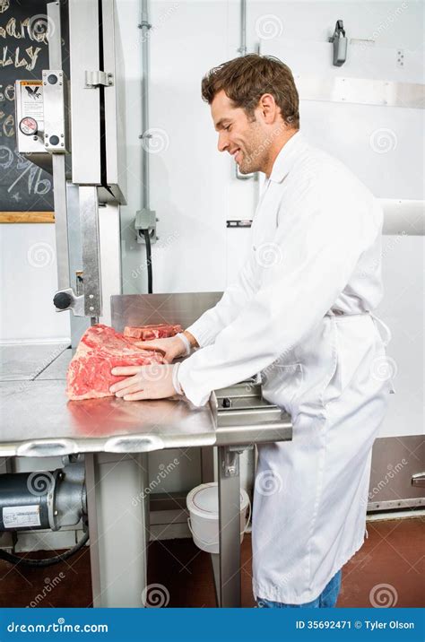 Smiling Butcher Slicing Meat On Bandsaw Stock Image Image Of Butcher