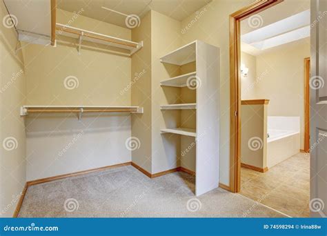 Empty Walk In Closet With Wood Shelves Beige Carpet Floor Stock Photo