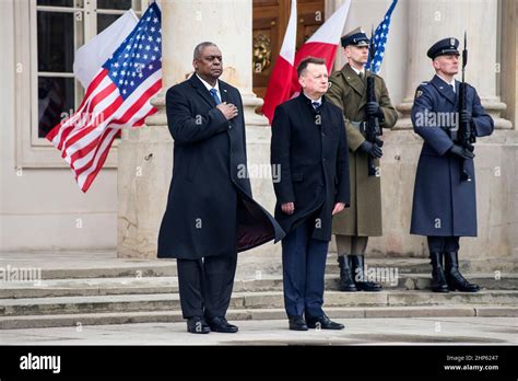 Lloyd Austin And Mariusz Blaszczak Are Listening To The US And Polish National Anthems Lloyd