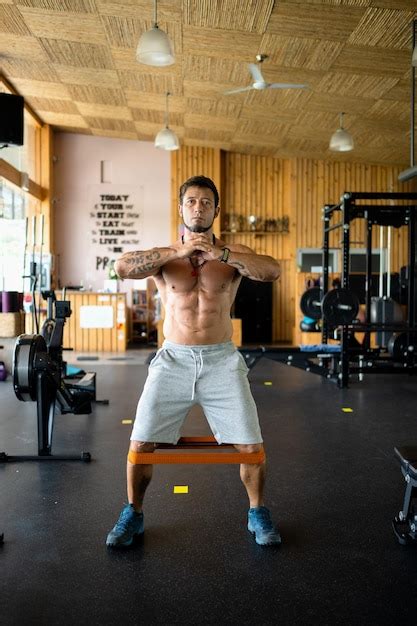 Premium Photo Man Doing Leg Exercises Using An Elastic Band