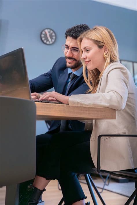 Business Colleagues Working Together On A Laptop In A Modern Office