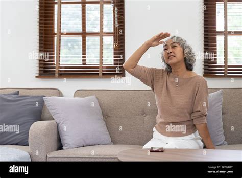 Asian Elderly Senior Female At Nursing Home Living Room Feeling Sad