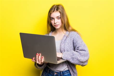 Free Photo Portrait Of A Smiling Teenage Girl Holding Laptop Computer