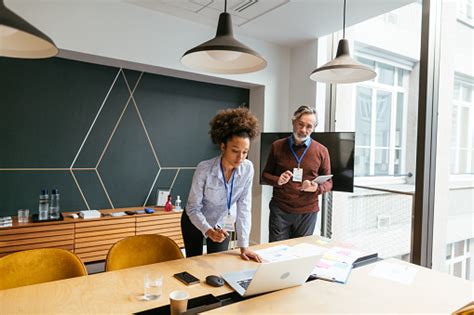 사무실의 팀워크는 창업 투자 계획을 개발하는 다양한 사업가들입니다 사무실에서 일하는 수석 고문 및 젊은 다인종 직원 25 29