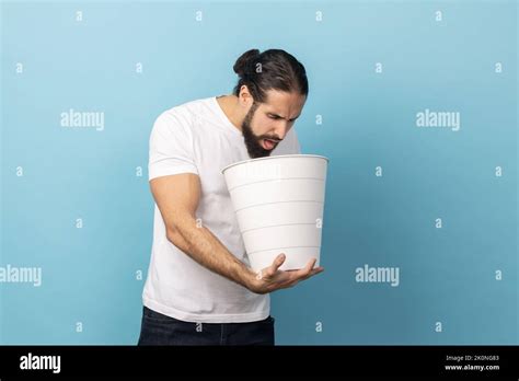 Portrait Of Man With Beard Wearing White T Shirt Vomiting Holding