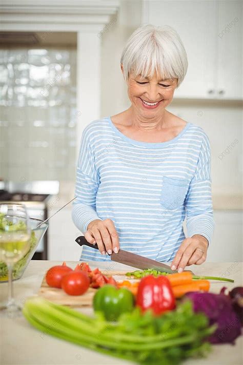 Senior Woman Cutting Vegetable Photo Background And Picture For Free