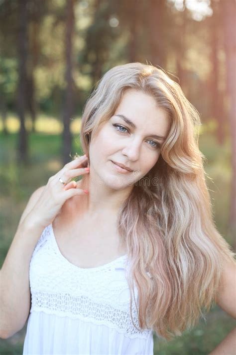 Portrait Of A Beautiful Young Woman With Long Hair On Nature Stock