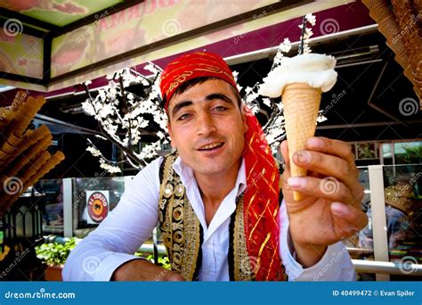 A Turkish Ice Cream Salesman Sells From A Spice And Candy Shop At Night