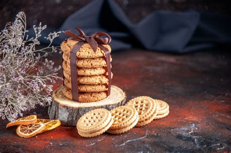 Free Photo Front View Delicious Sweet Cookies Tied With Bow On Dark
