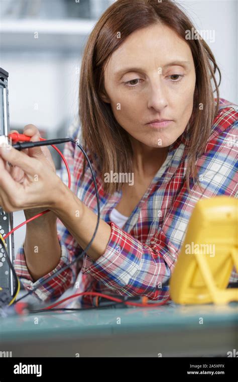 A Woman Checking Voltage Pc Stock Photo Alamy