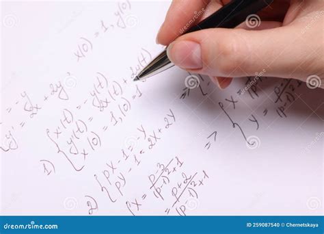 Student Writing Different Mathematical Formulas On Paper Closeup Stock