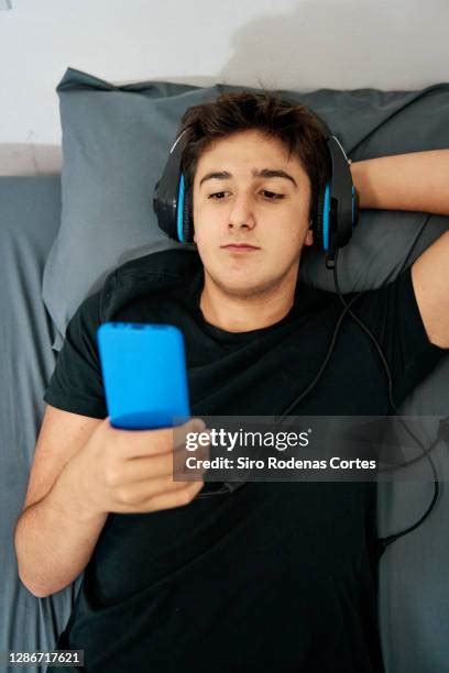Boy Texting In Bed Photos And Premium High Res Pictures Getty Images