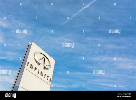 Infiniti Nissan Motor Brand Logo On Bright Blue Sky Background Located