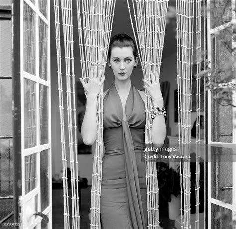 Dovima Standing In The Doorway Of Penthouse Holding A Wooden Beats