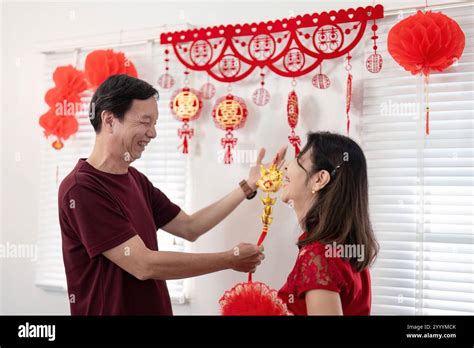 Elderly Couple Celebrates Chinese New Year At Home Festive Decorations