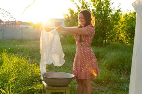 Young Woman Hanging Laundry Outdoors Beautiful Girl In Red Polkadot