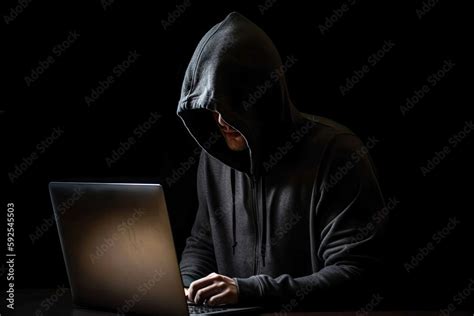 Hacker Working On Laptop Anonymous Hooded Hacker Breaking Into Data